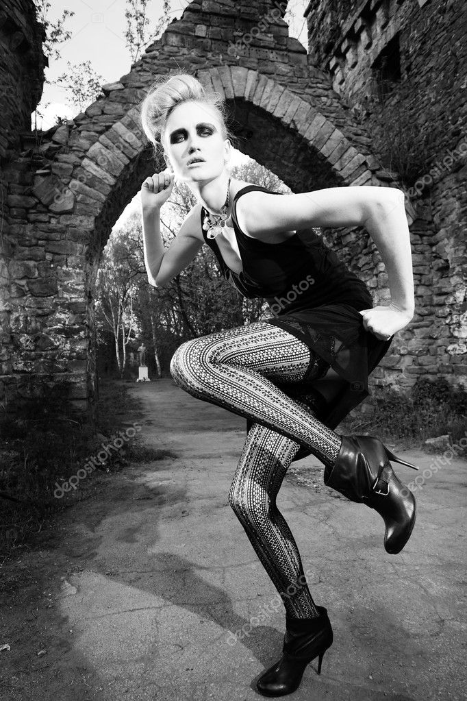 Fashion model in front of the gate Stock Photo by ©krivenko 3178591