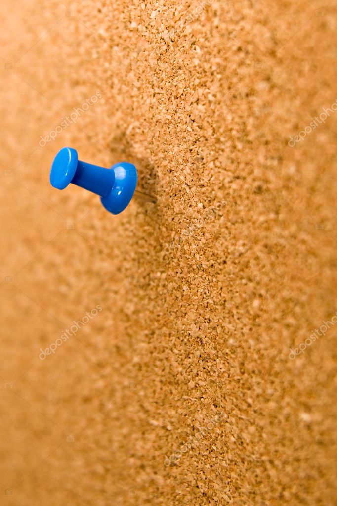 Blue push pins stuck into a cork board. — Stock Photo © peresanz #2708026