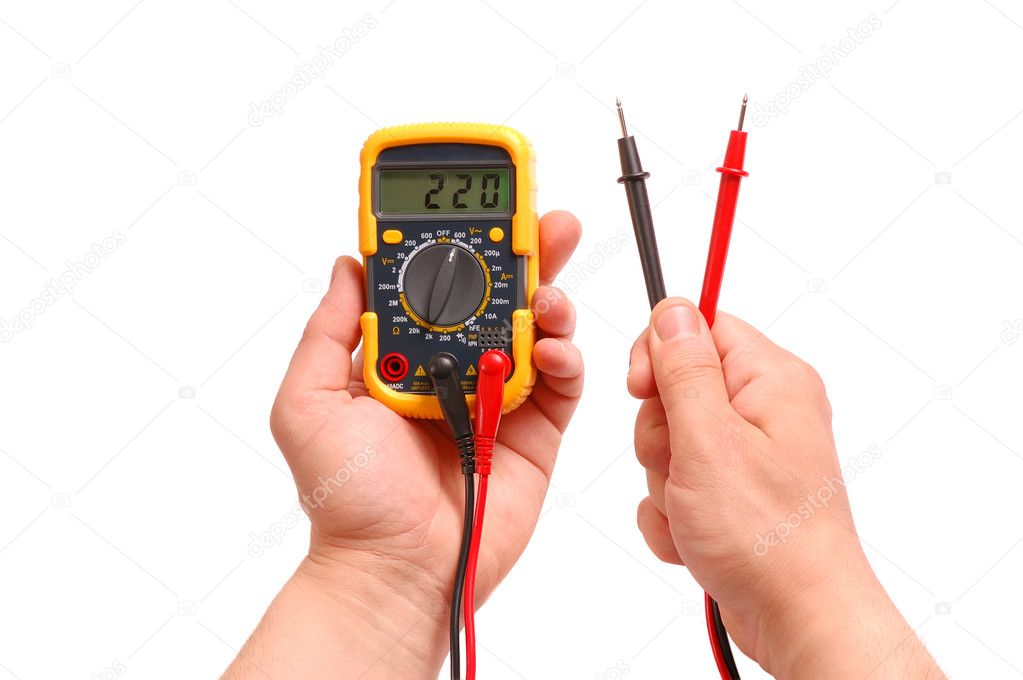 Hands with a digital multimeter on white Stock Photo by ©McAndy 2778359