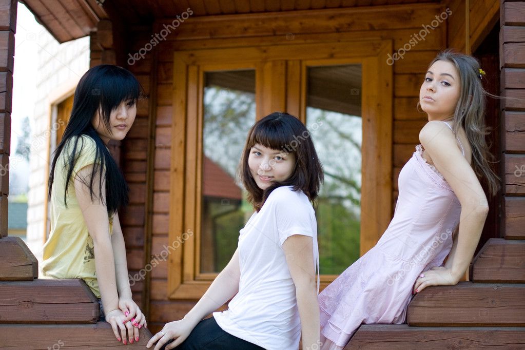 Three female friends on a veranda — Stock Photo © Zoreslava #3387660