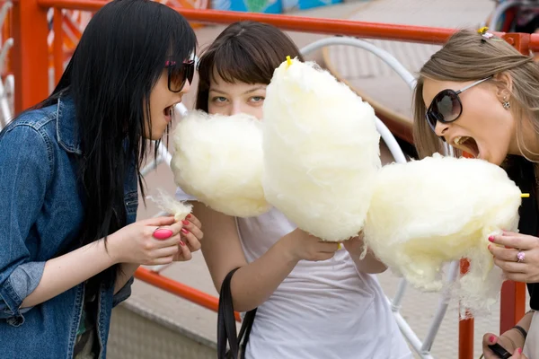 Three girls eating candy floss - Stock Image - Everypixel
