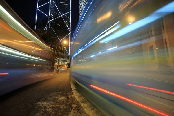 Bus speeding through night street. Hong Kong, Ch - Stock Image - Everypixel