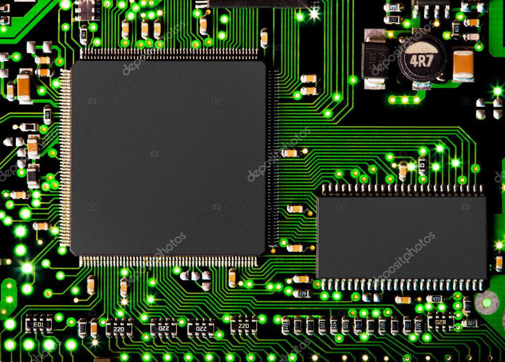 Close up of computer circuit board in green with transistors and ...