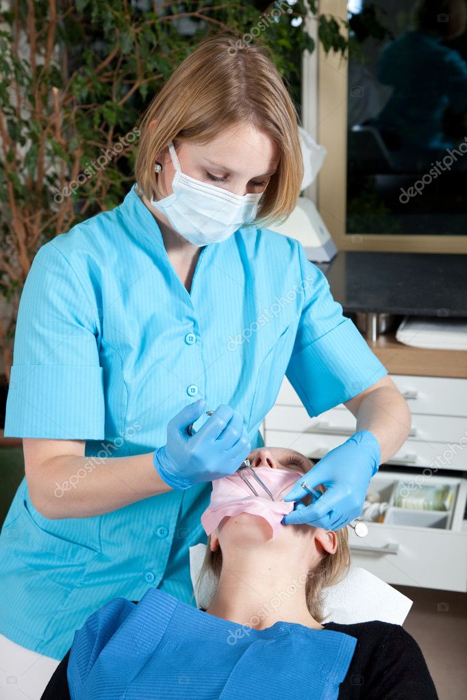 Female dentist working on her patient — Stock Photo © Fotosmurf #2979579