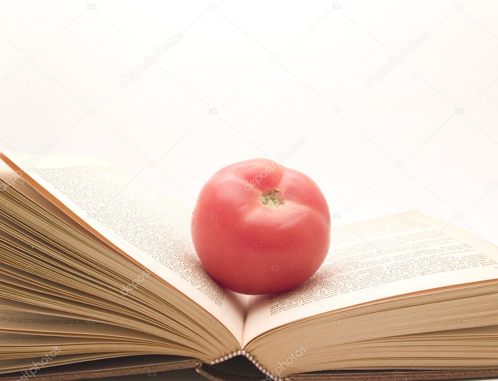 Book and tomato — Stock Photo © lauria #3004501