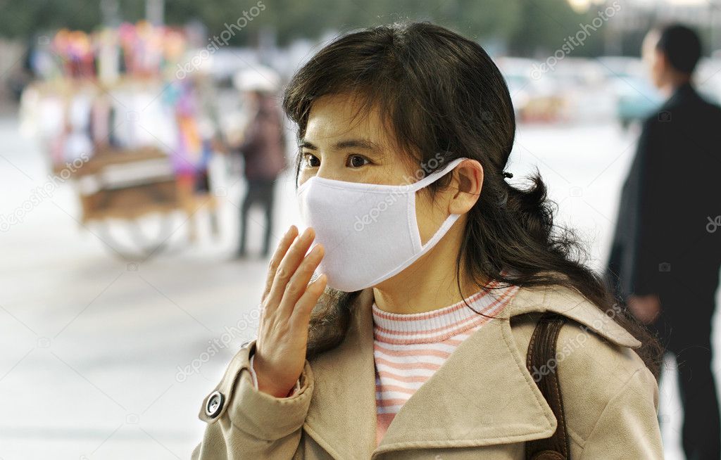 Asian woman wearing a face mask — Stock Photo © barnabychambers #3068366