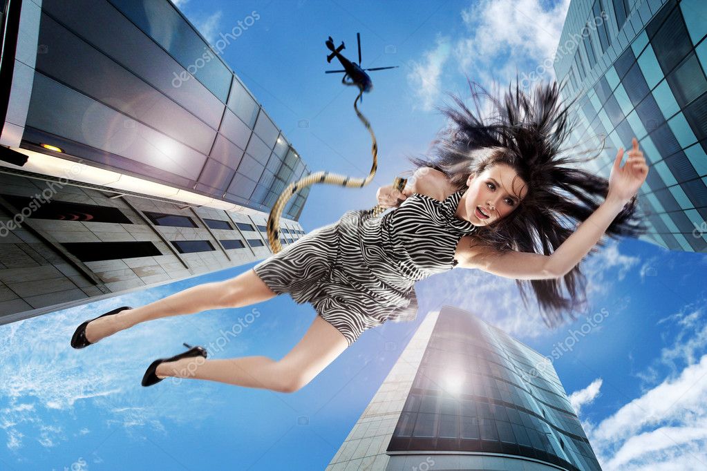 Young brunette falling down the sky — Stock Photo © konradbak #4580296