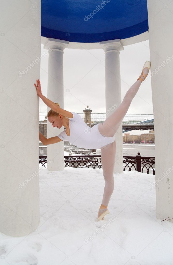 The ballerina in the Rotunda dances ballet in the winter on snow ...