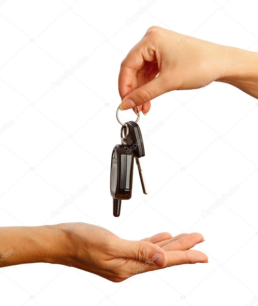 Female hand holding a car key and handing it over to another person ...